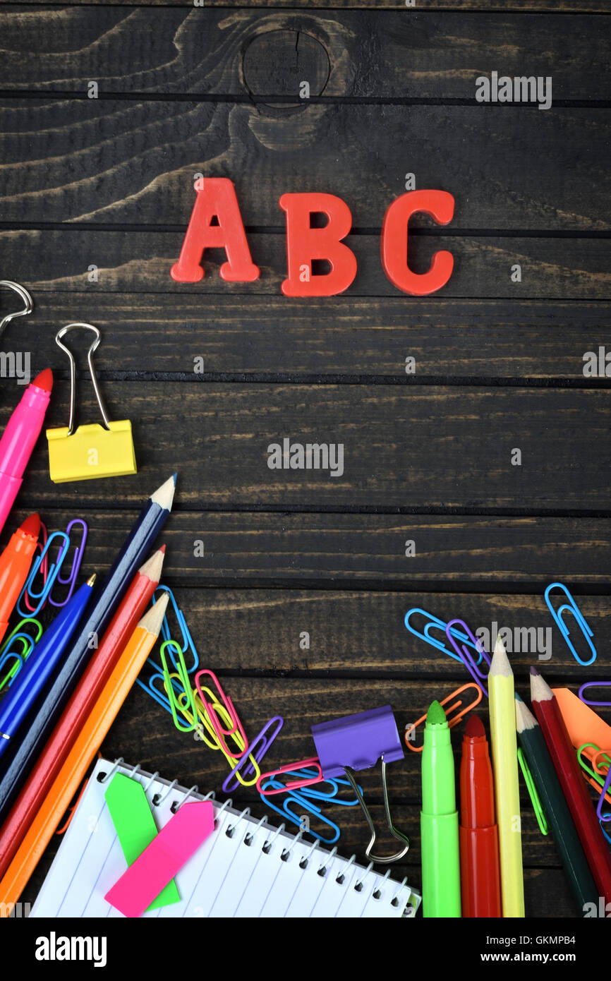 ABC and office tools on wooden table Stock Photo - Alamy