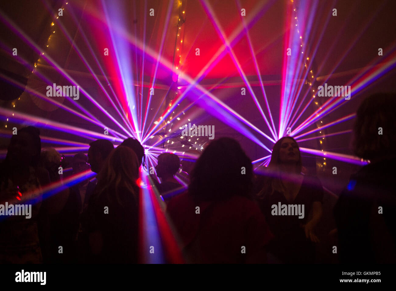 Guests dance at a disco following a wedding in Essex, eastern England ...