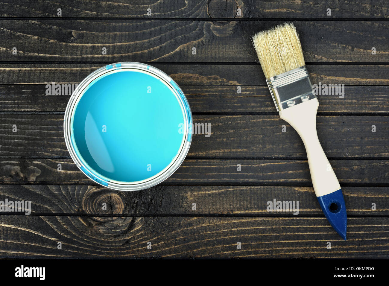 Paint bucket and brush on wooden table Stock Photo - Alamy