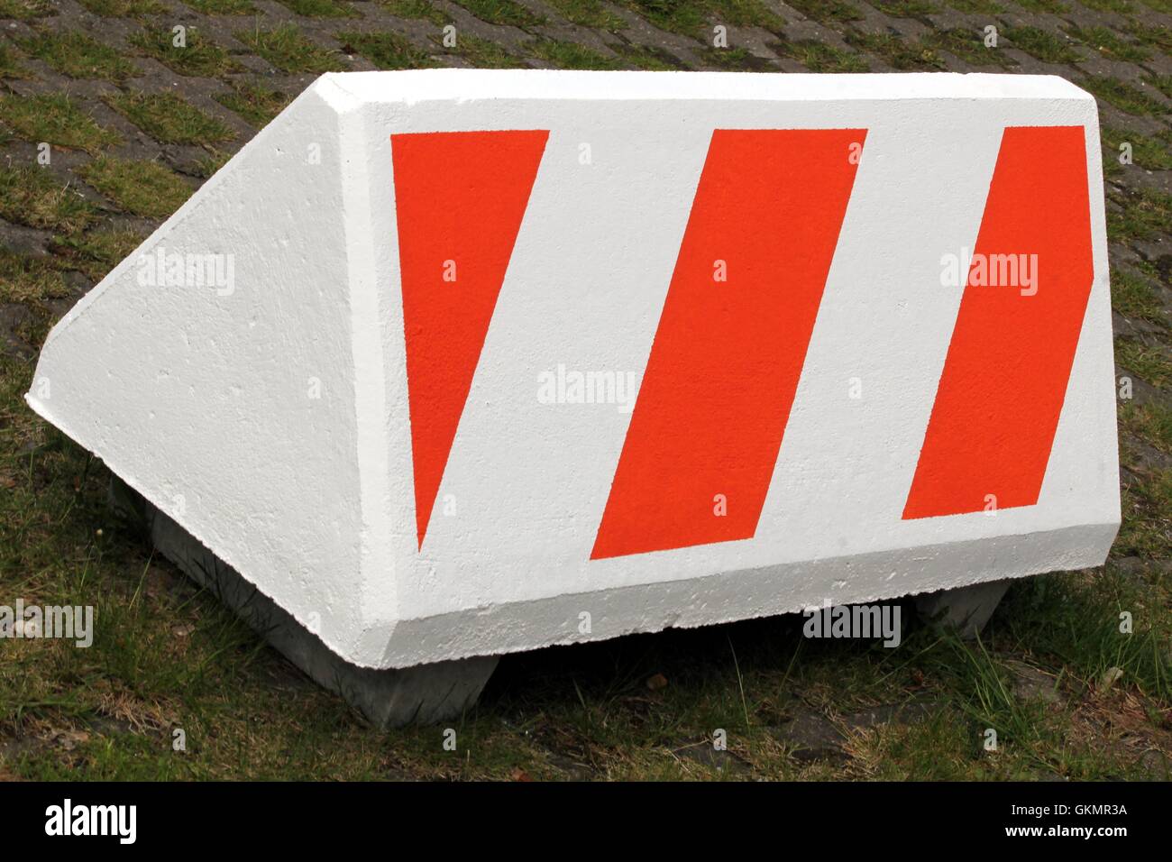 warning symbol on big concrete block Stock Photo - Alamy