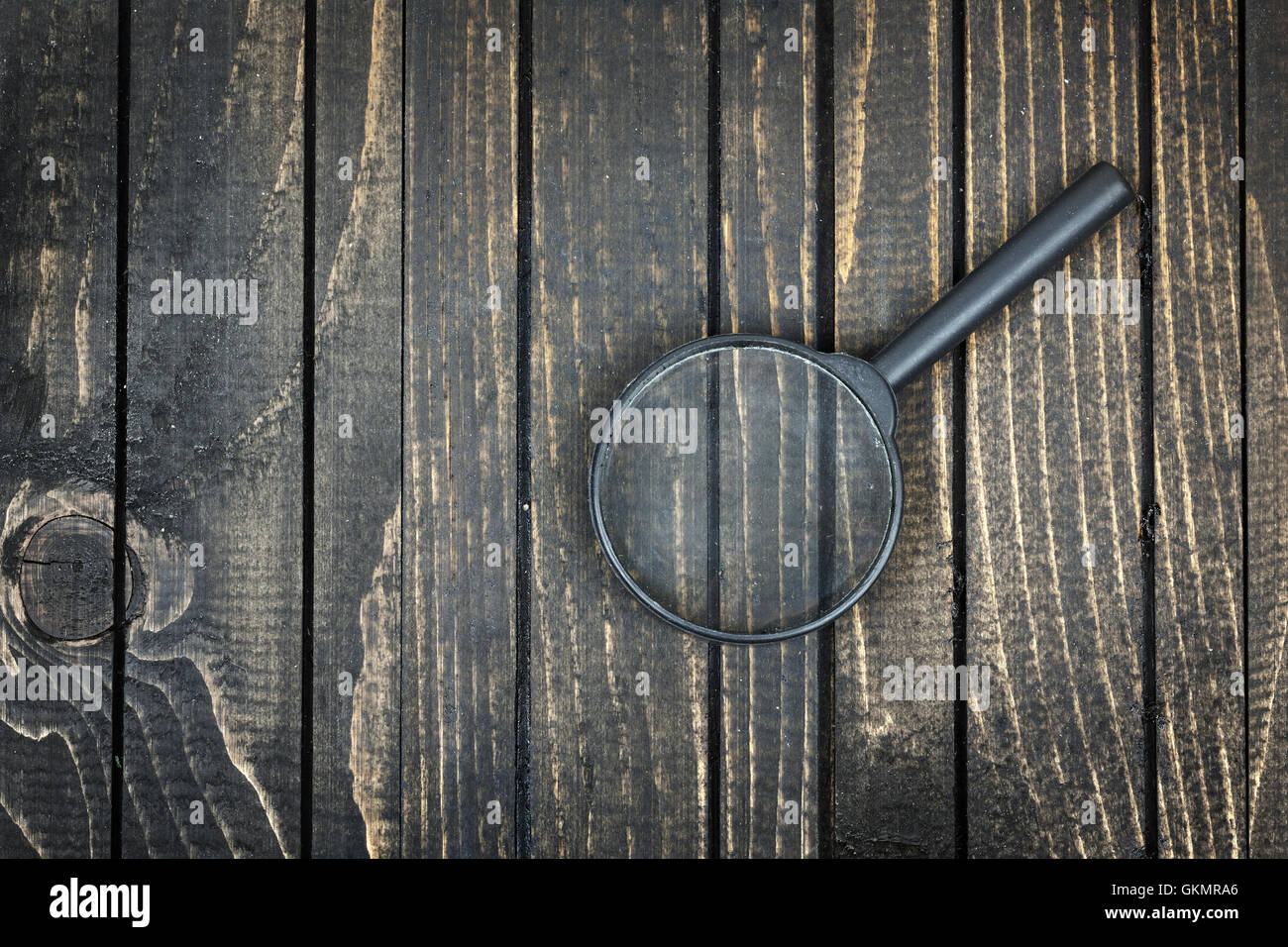 Magnifying glass on wooden table Stock Photo - Alamy