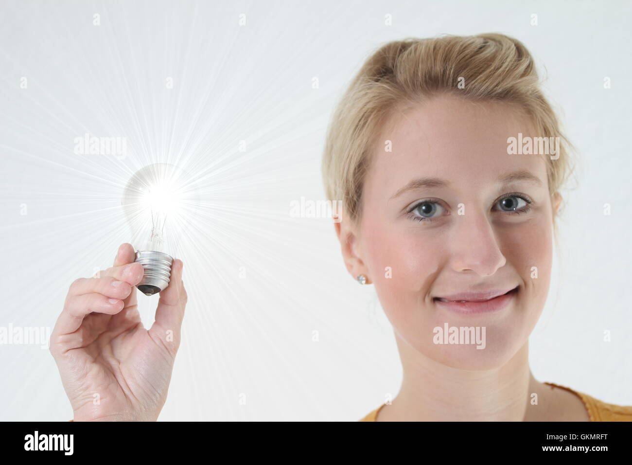 girl with glowing light bulb Stock Photo - Alamy
