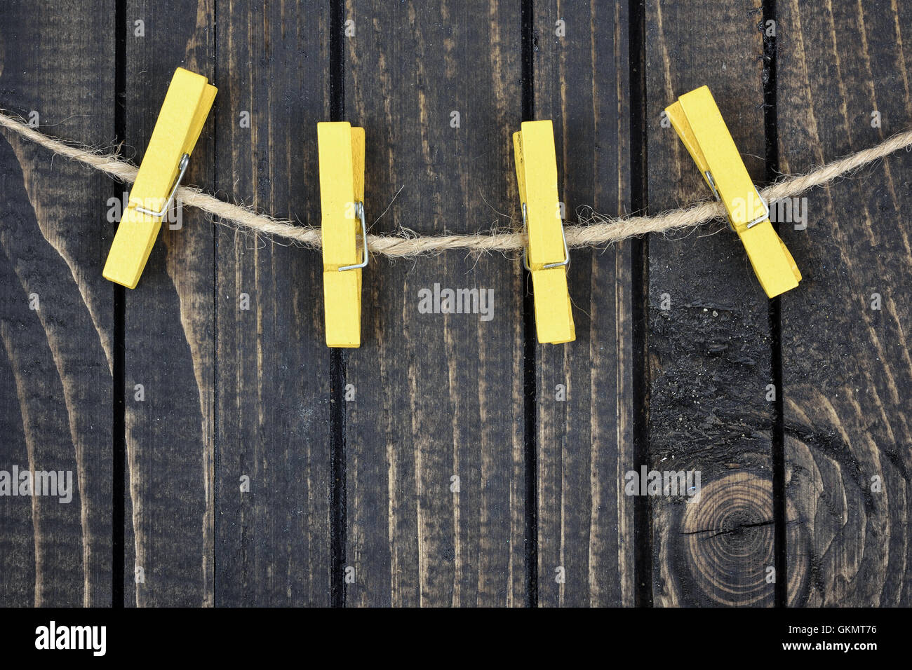 Four clips on wooden wall Stock Photo - Alamy