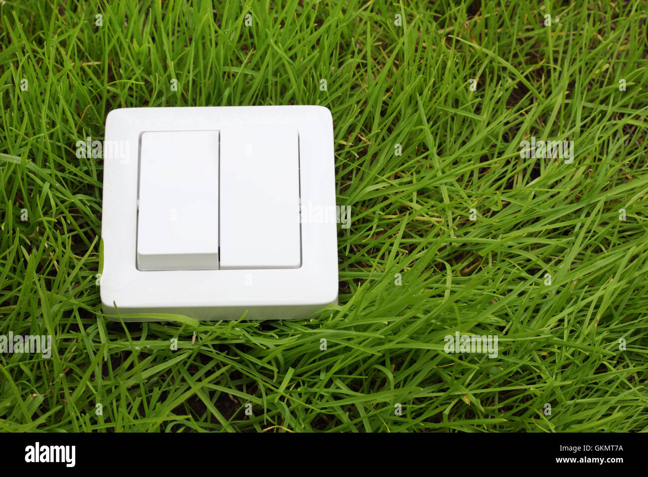 light switch on a green grass background Stock Photo - Alamy