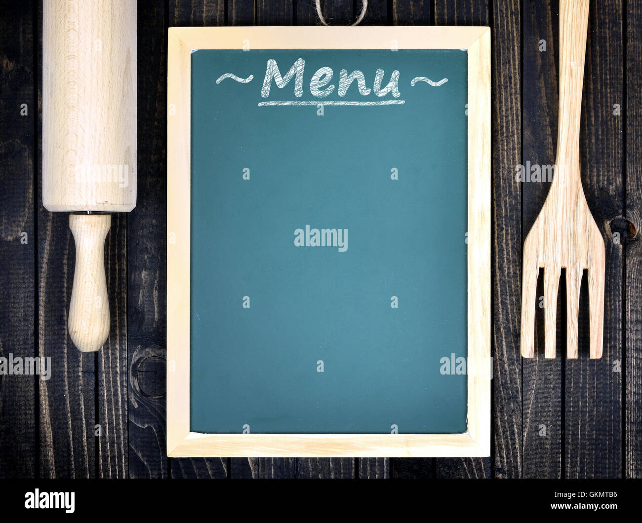 Kitchen utensils and menu on wall Stock Photo - Alamy