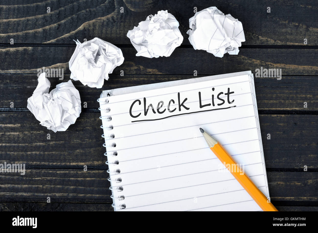 Check list on notepad and crippled paper Stock Photo - Alamy