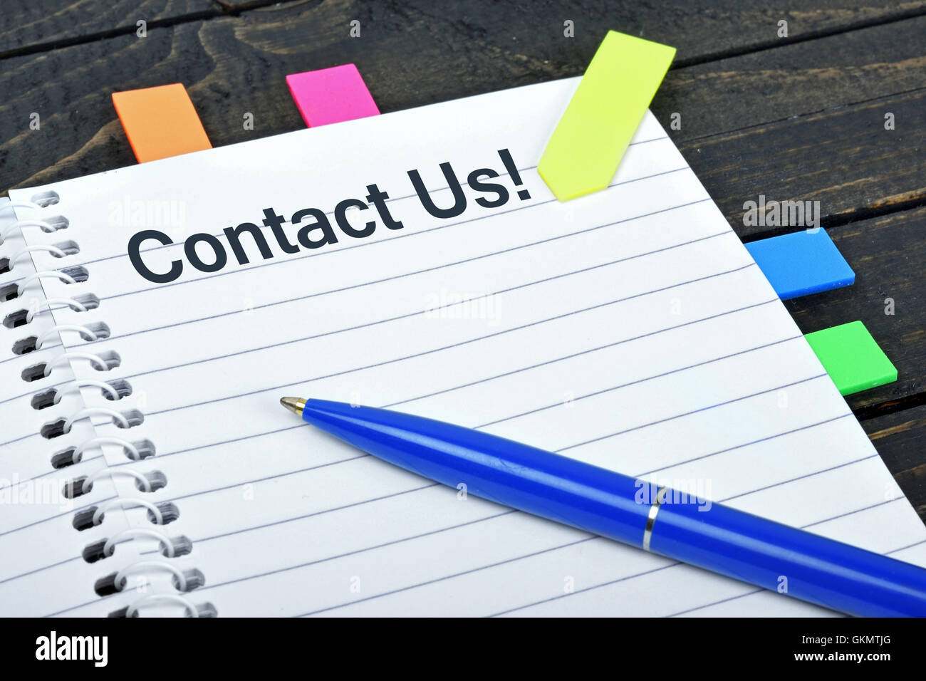 Contact us word on notepad and pen Stock Photo - Alamy