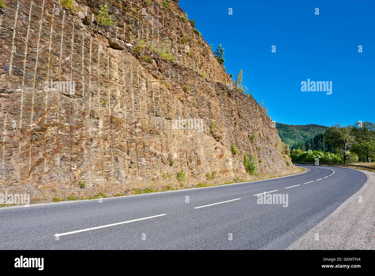 Rock above Road Stock Photo - Alamy