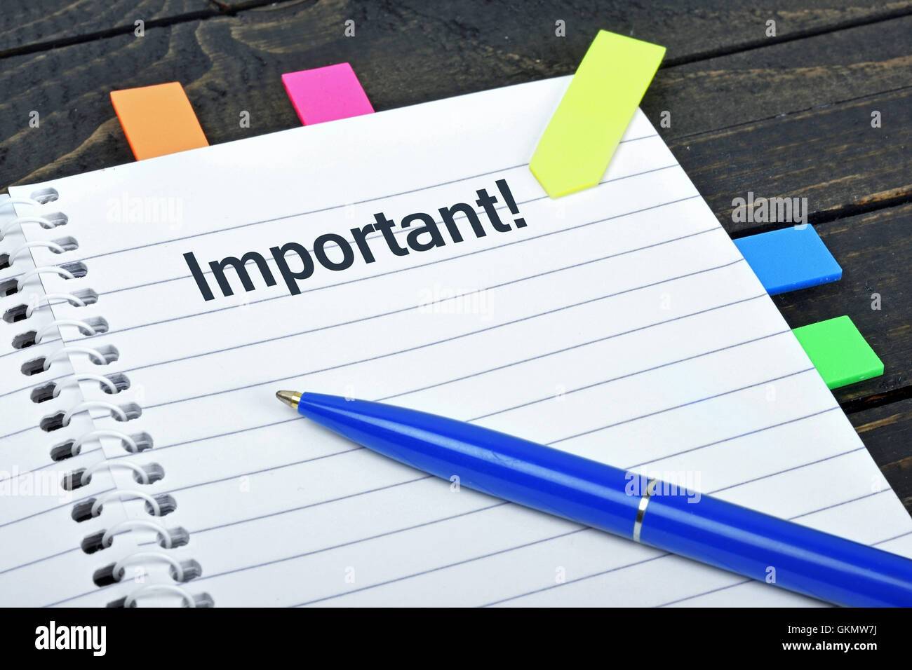 Important word on notepad and pen Stock Photo - Alamy