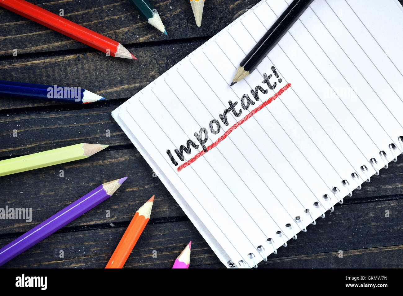 Important text on notepad and colorful pencils Stock Photo - Alamy