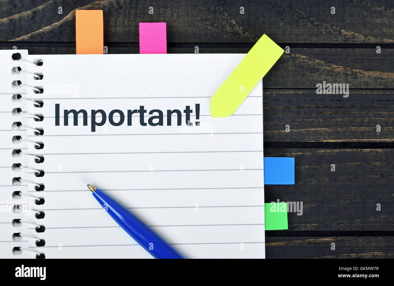 Important word on notepad and pen Stock Photo - Alamy