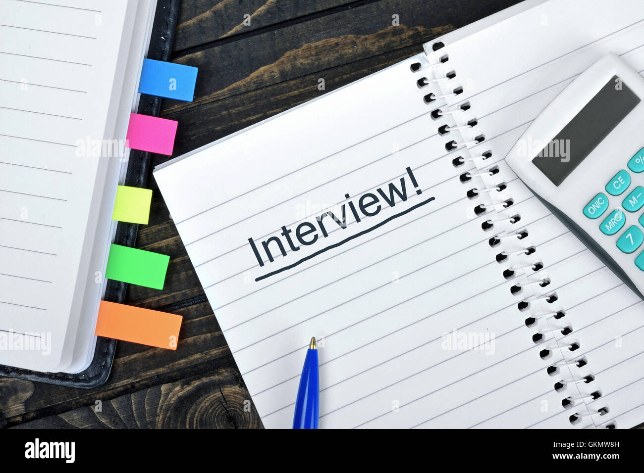 Interview text on notepad and hand calculator Stock Photo - Alamy