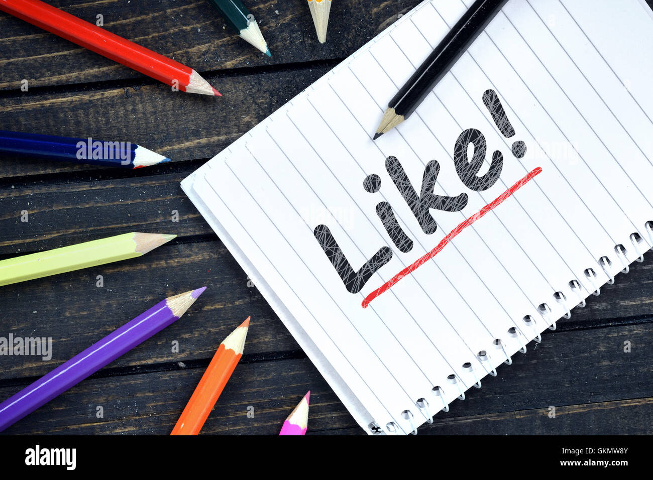 Like text on notepad and colorful pencils Stock Photo - Alamy