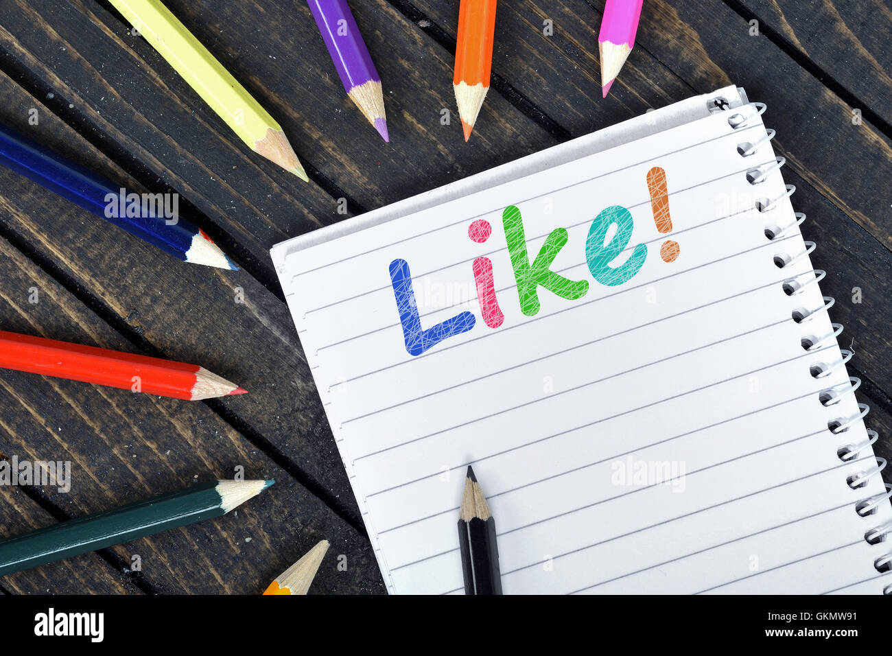 Like text on notepad and colorful pencils Stock Photo - Alamy