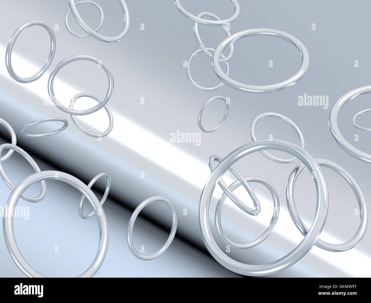 Abstract metallic rings falling on shined grey background Stock Photo ...