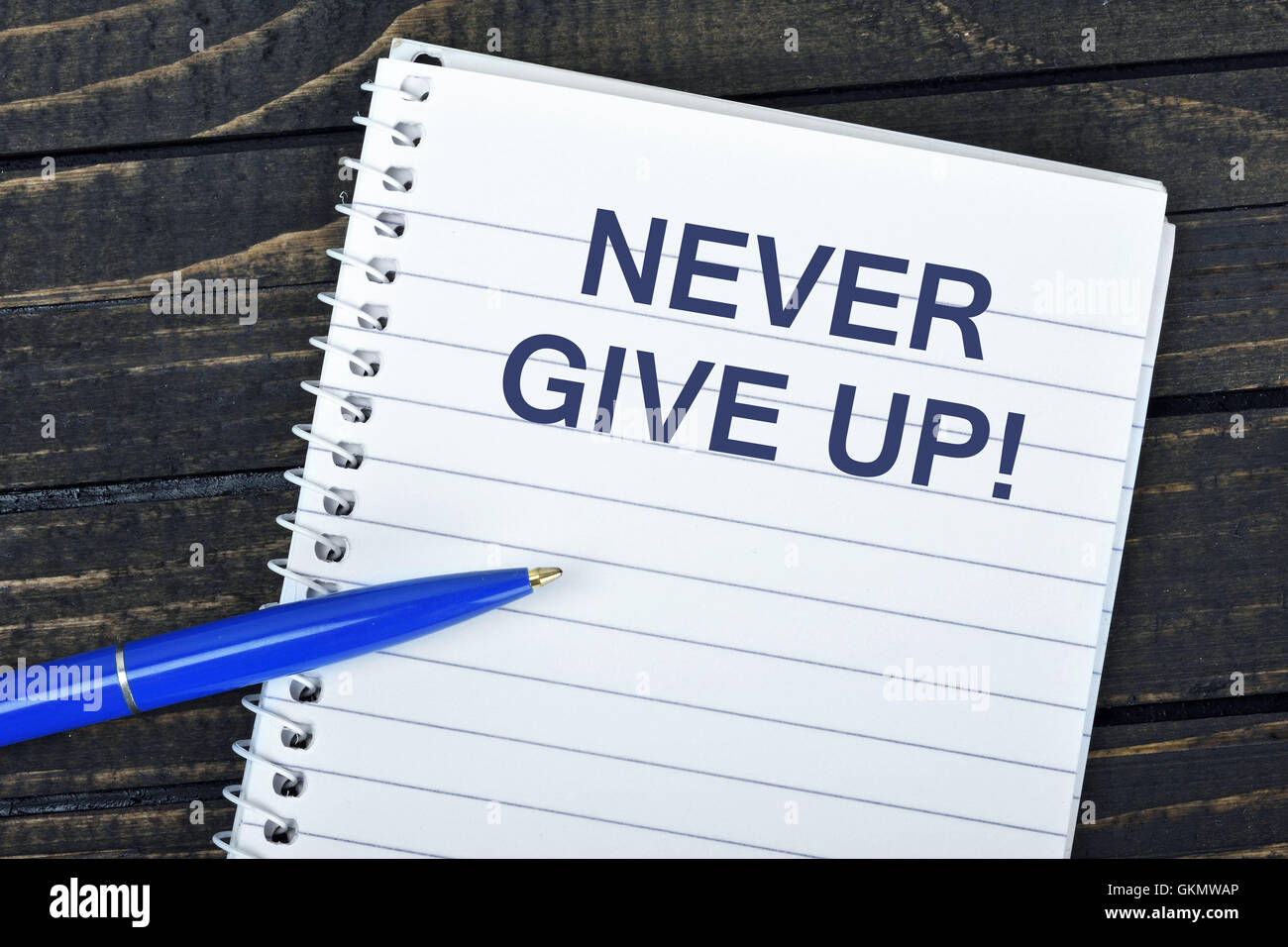 Never Give Up text on notepad and blue pen Stock Photo - Alamy
