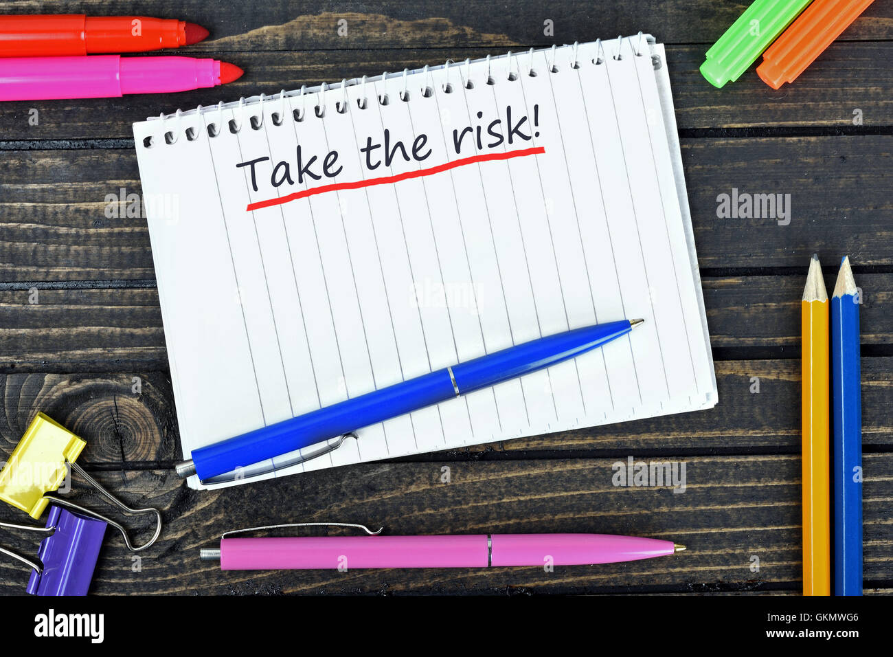 Take the risk text on notepad and office tools on wooden table Stock ...