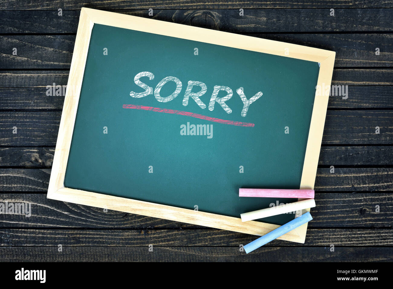 Sorry text on school board and chalk Stock Photo - Alamy