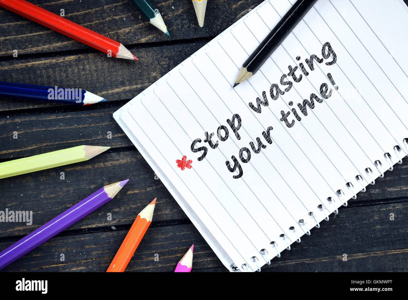 Stop wasting your time text on notepad and colorful pencils Stock Photo ...