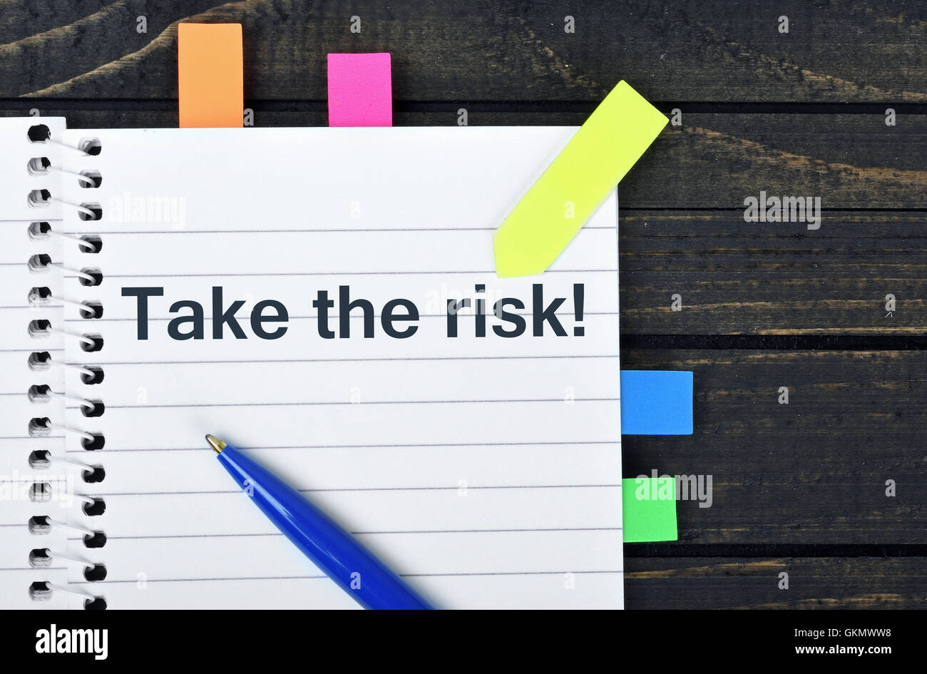 Take risk word on notepad and pen Stock Photo - Alamy