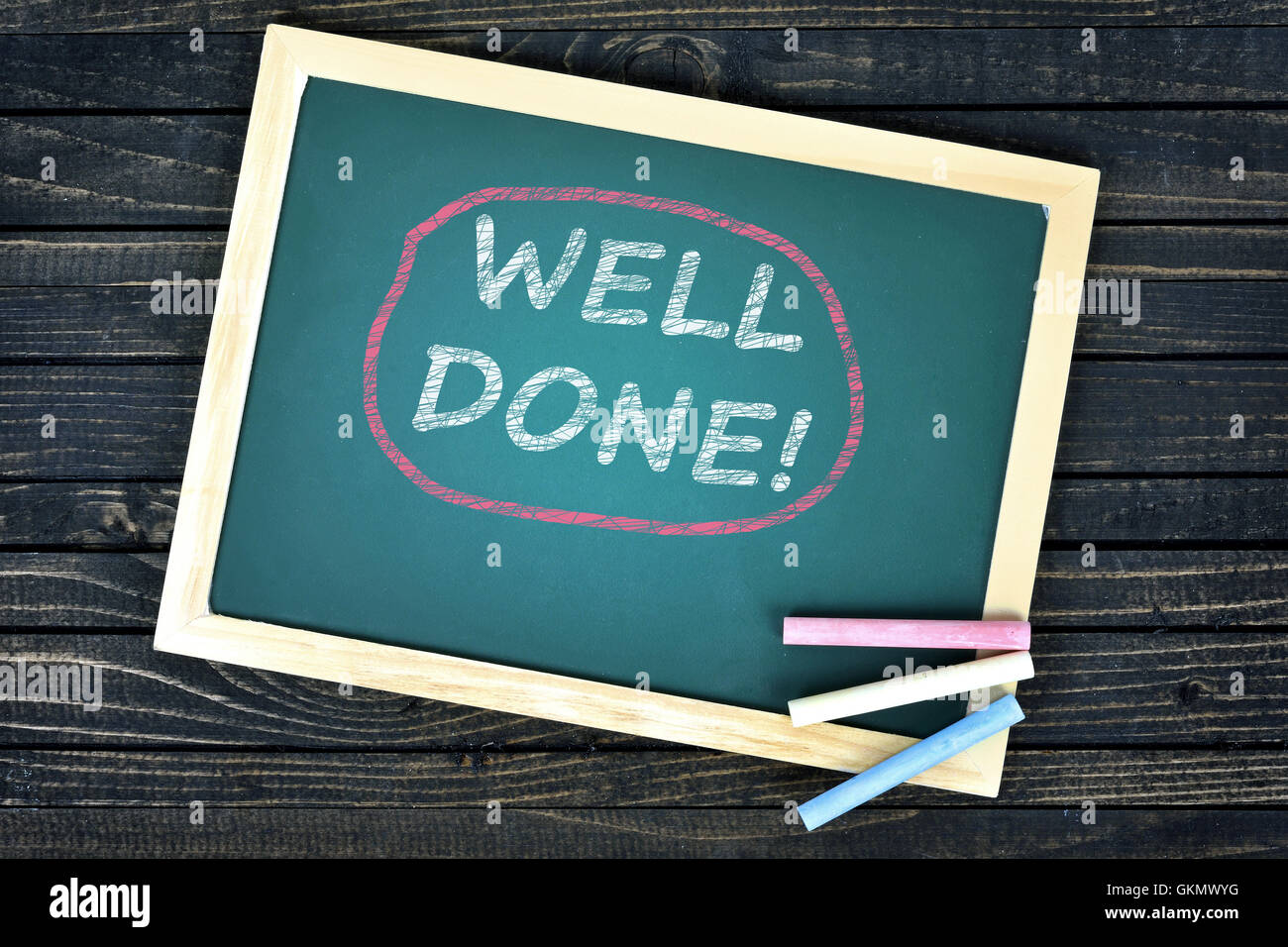 Well done text on school board and chalk Stock Photo - Alamy