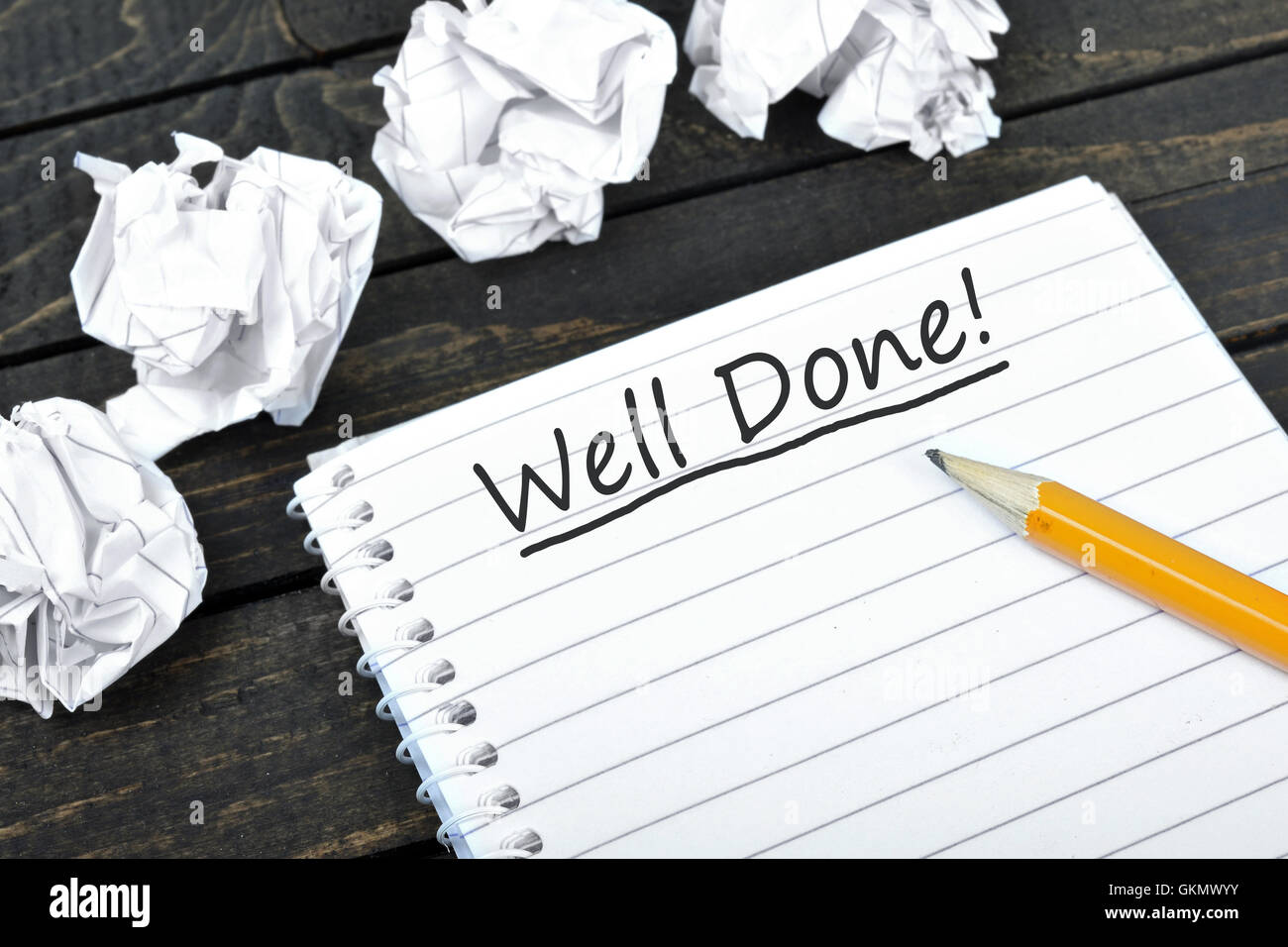 Well done text on notepad and crippled paper Stock Photo - Alamy
