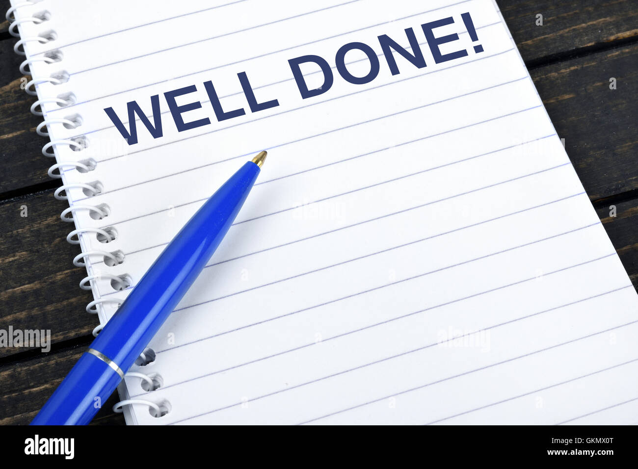 Well Done text on notepad and blue pen Stock Photo - Alamy