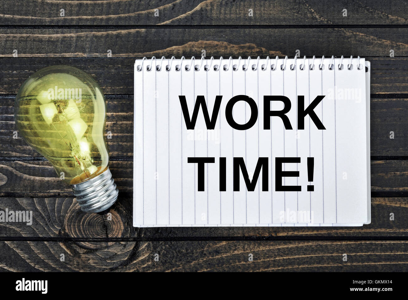 Work time text on notepad and light bulb Stock Photo - Alamy