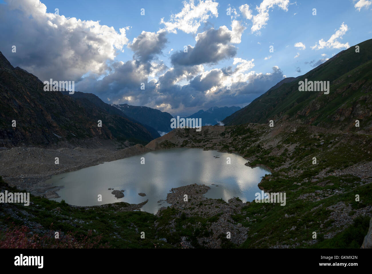 glacial lake and moraines on the background of cloudy mountains Stock ...