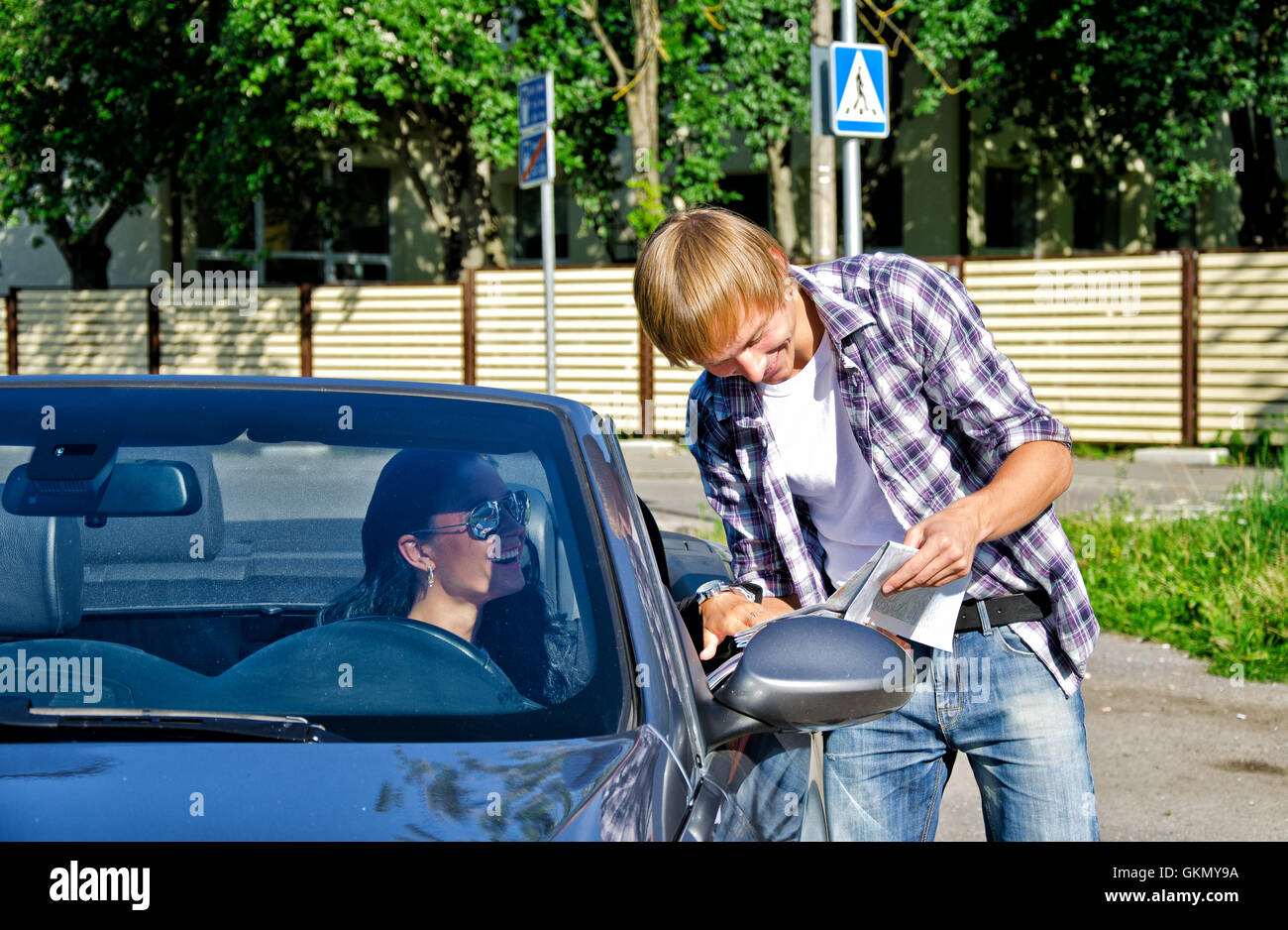 Male tourist asking female driver about direction Stock Photo - Alamy