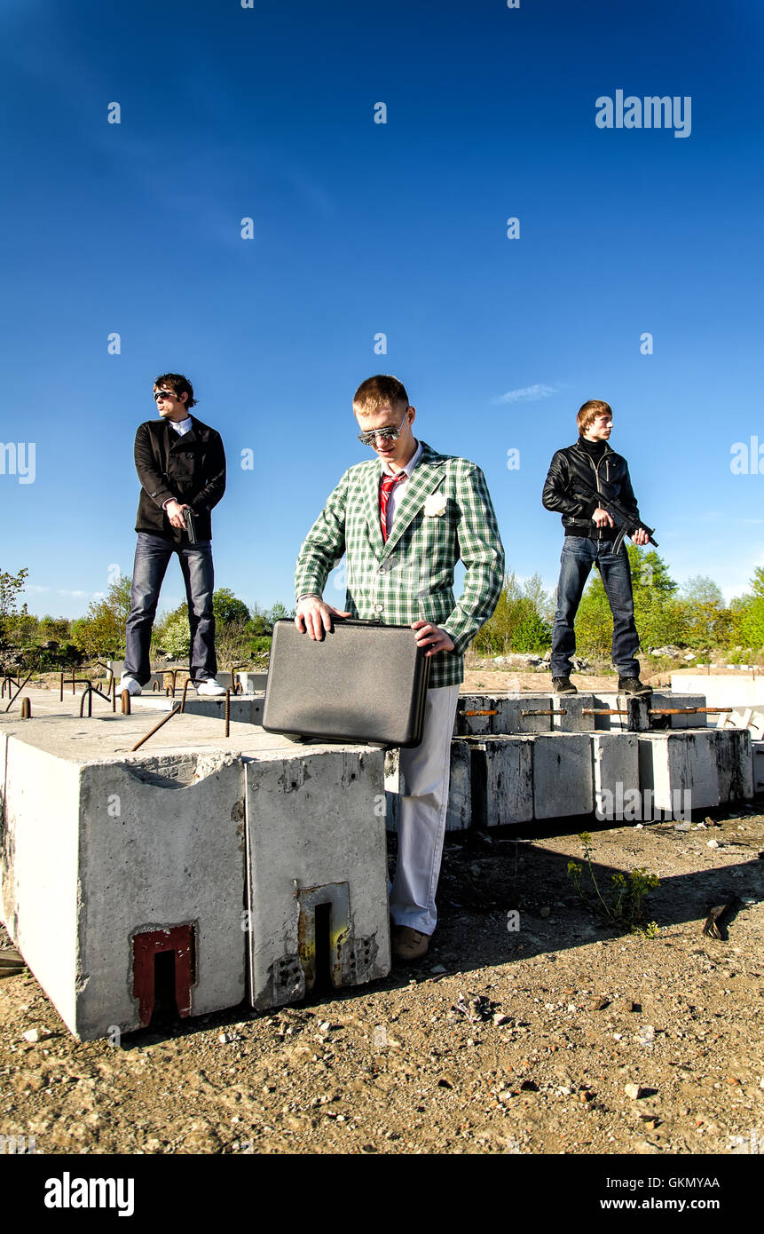 Mafia: Three thugs with a suitcase and weapons Stock Photo - Alamy