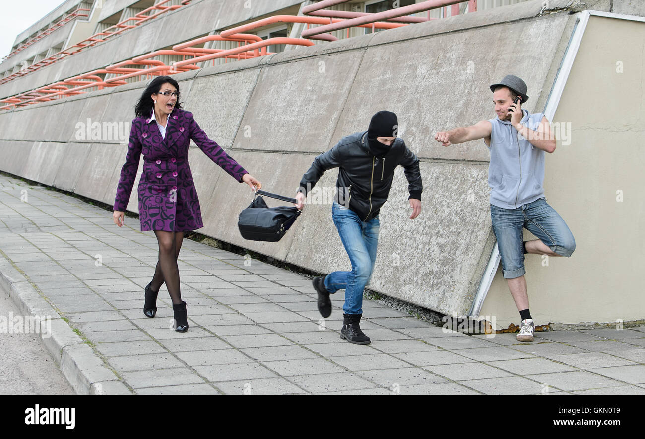Robbery prevention on the street. Thief try to steal a bag Stock Photo ...