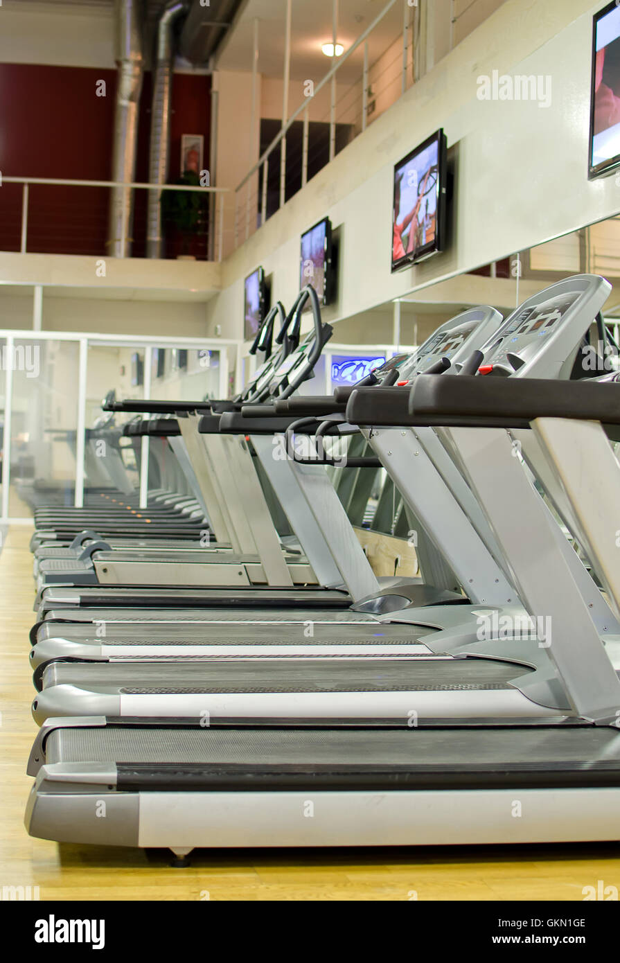 Athletic treadmills in the fitness club Stock Photo - Alamy