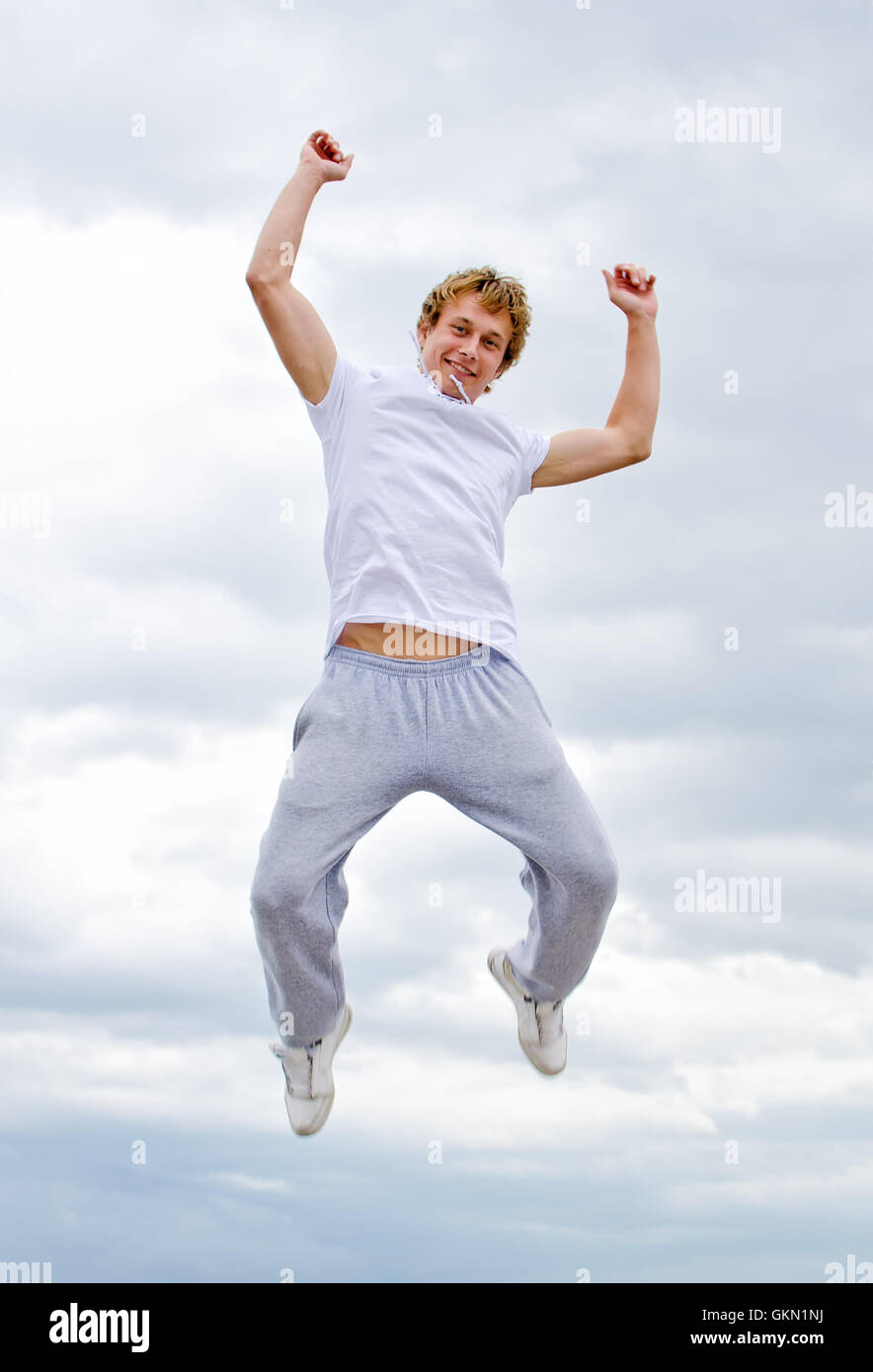Portrait of young man jumping hi-res stock photography and images - Alamy