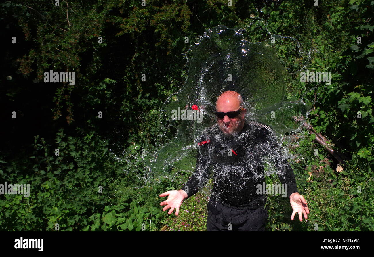Man hit with water balloon Stock Photo - Alamy