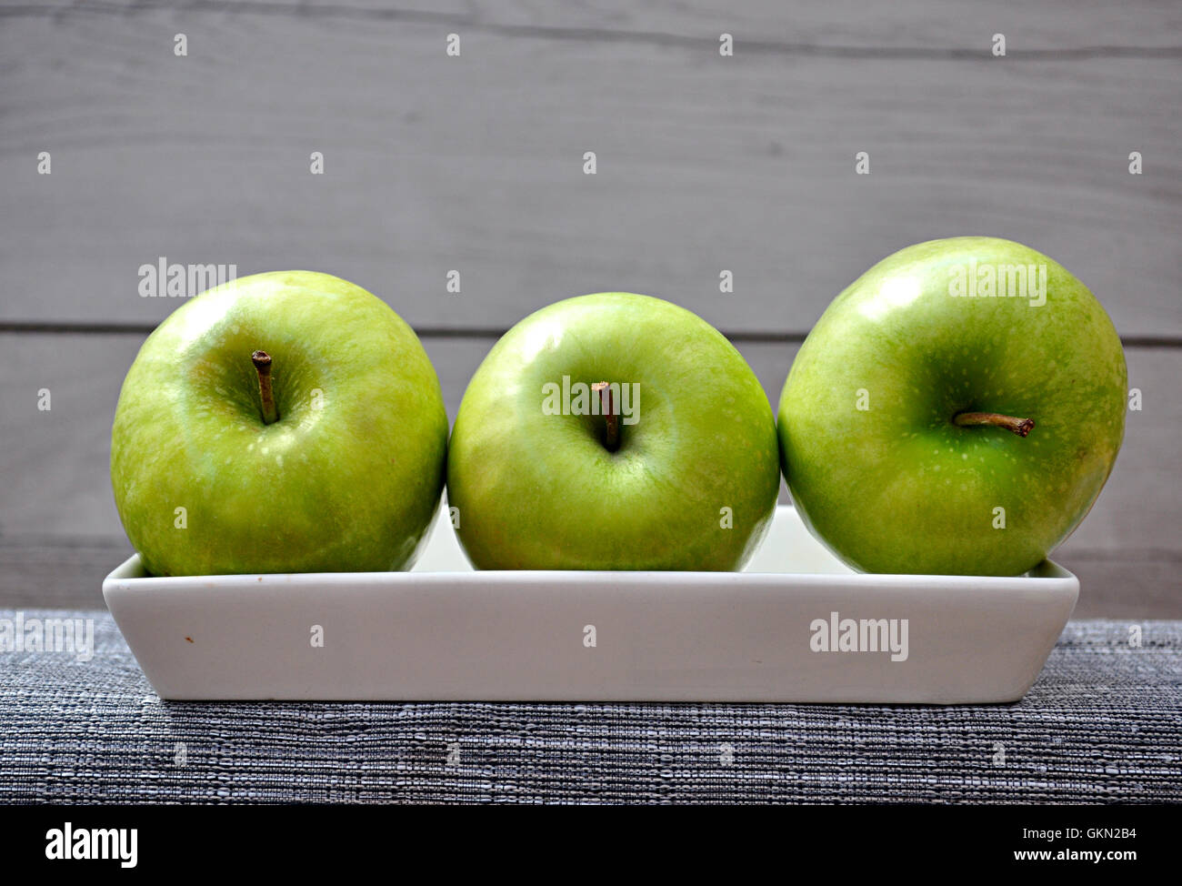 three apples on plate Stock Photo - Alamy