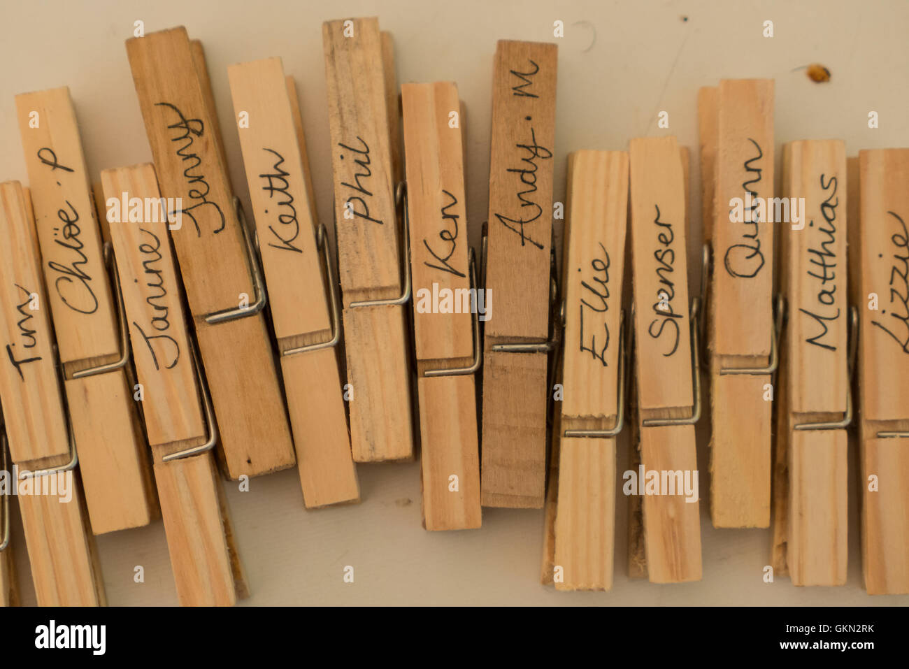 Clothes pegs with names of wedding guests Stock Photo - Alamy
