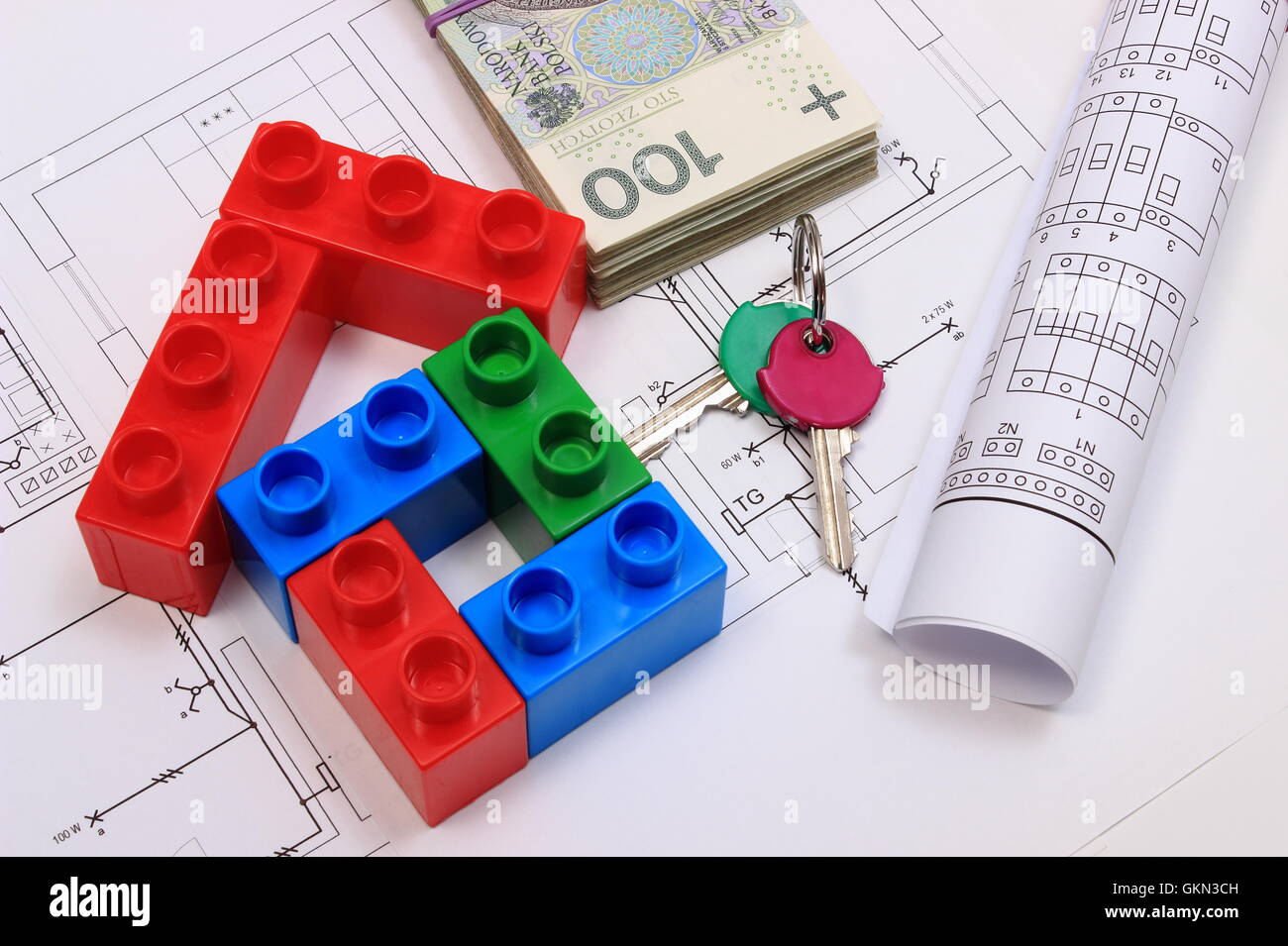 House of colorful building blocks, home keys, banknotes and electrical ...