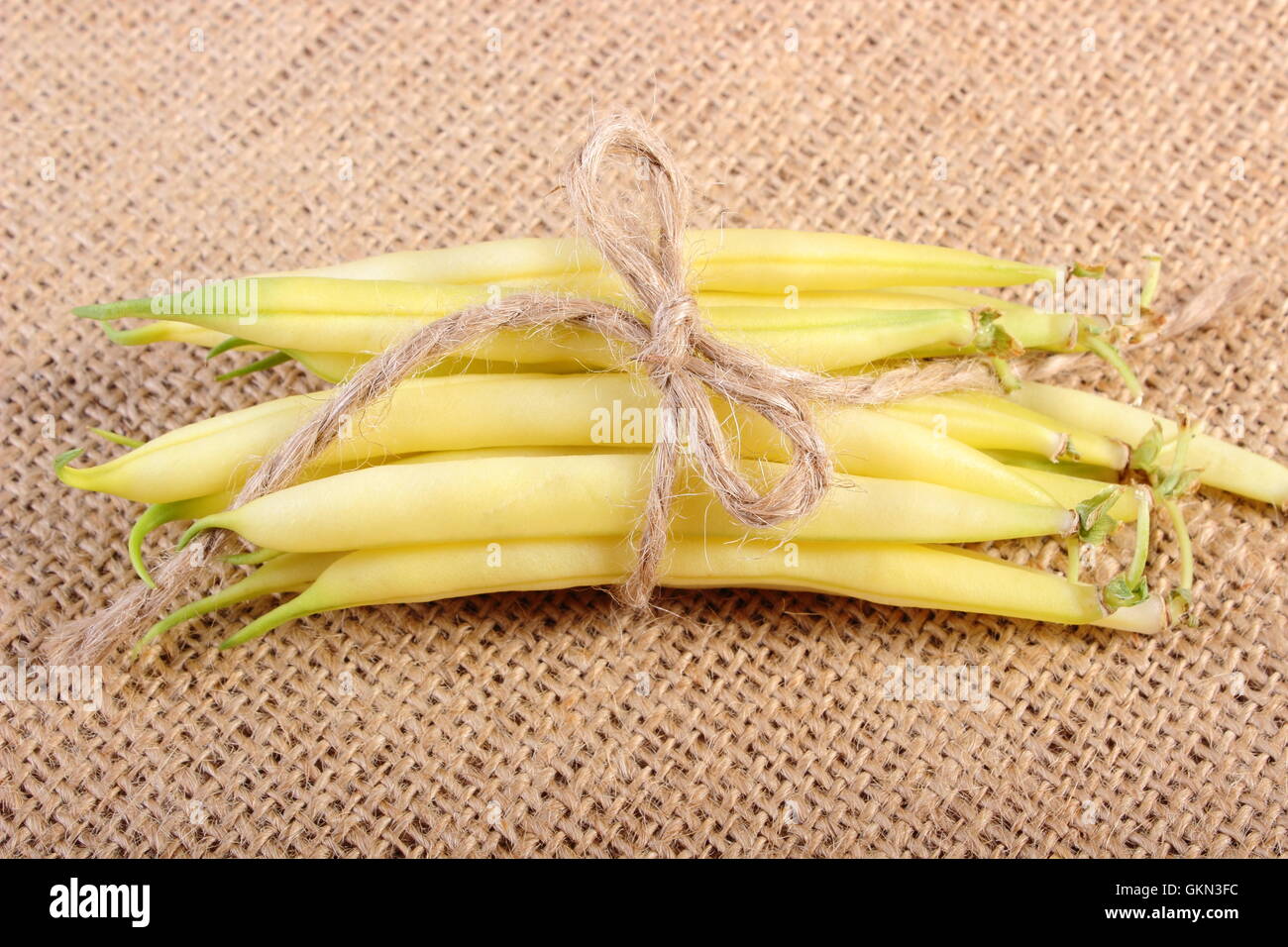 Stack of beans tied with string lying on jute canvas, healthy food and ...