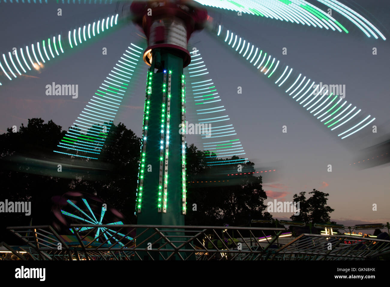 Amusement park ride at a county fair at dusk Stock Photo - Alamy