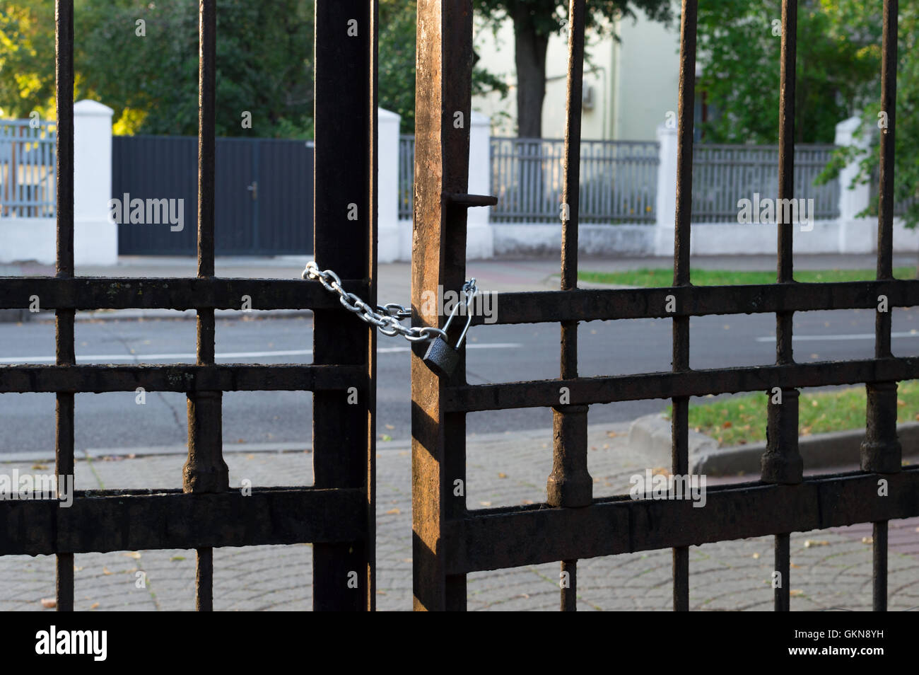 Chain and lock on the iron fence. City street outside Stock Photo - Alamy