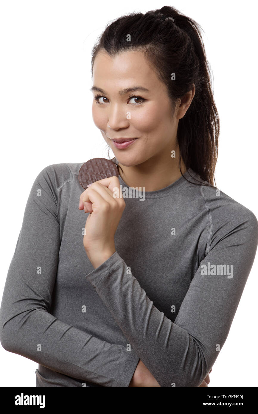 fitness woman having a cheeky chocolate biscuits Stock Photo - Alamy