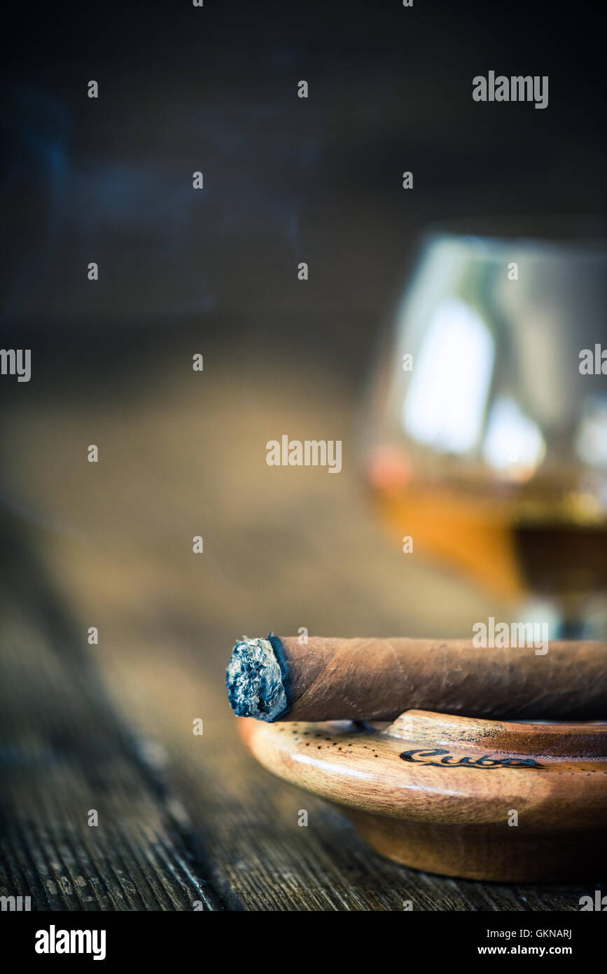 smoking cigar close up view, in wooden ashtray Stock Photo - Alamy