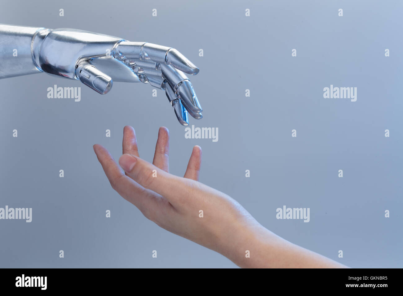 Robot hand and woman's hand Stock Photo - Alamy