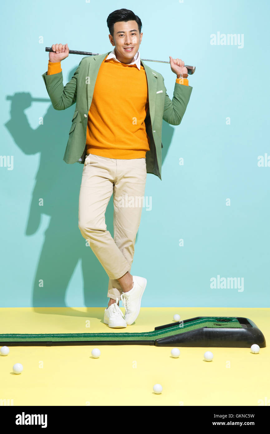 Young man playing golf Stock Photo - Alamy