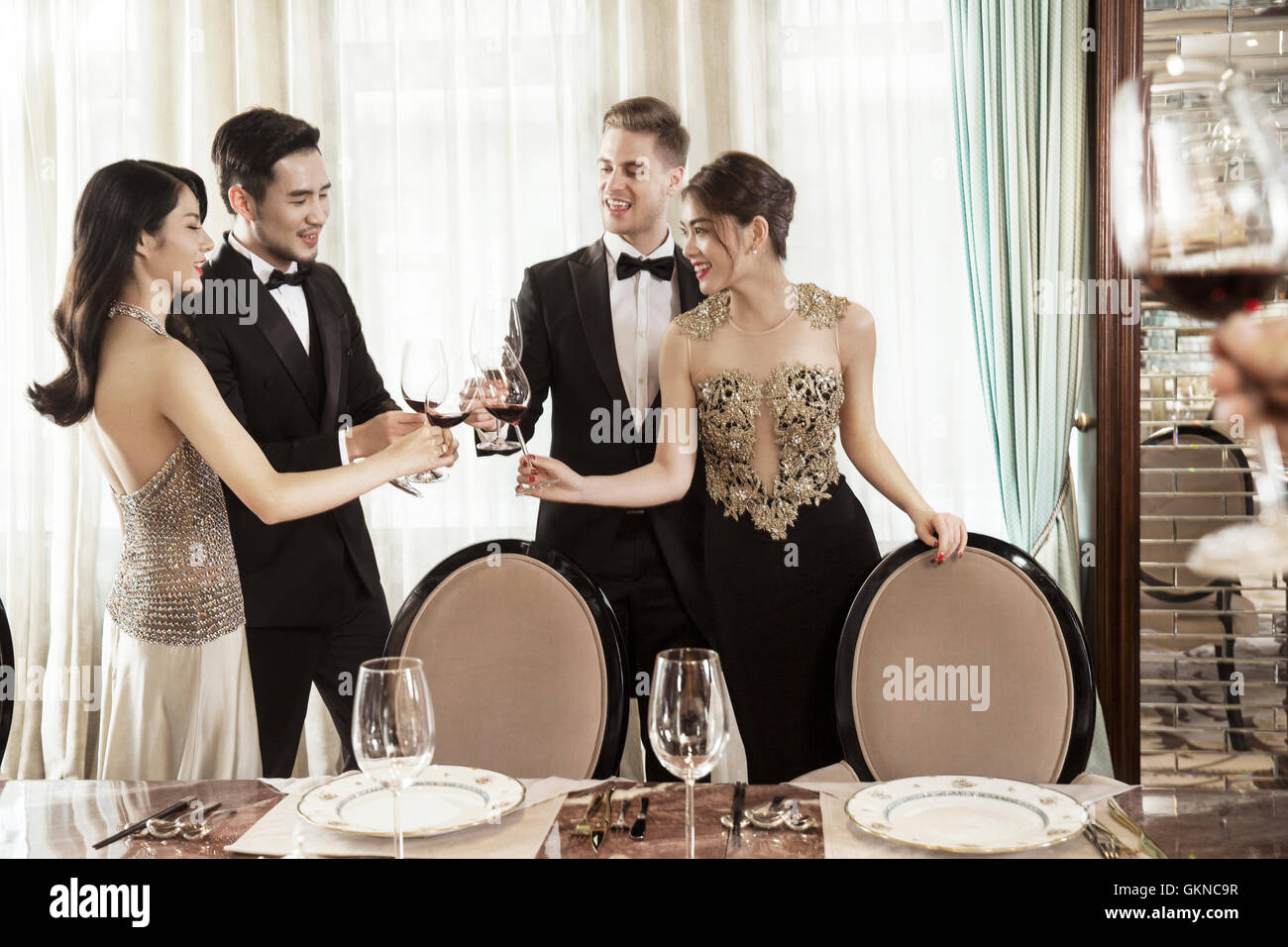 Multi ethnic family at a dinner table hi-res stock photography and ...
