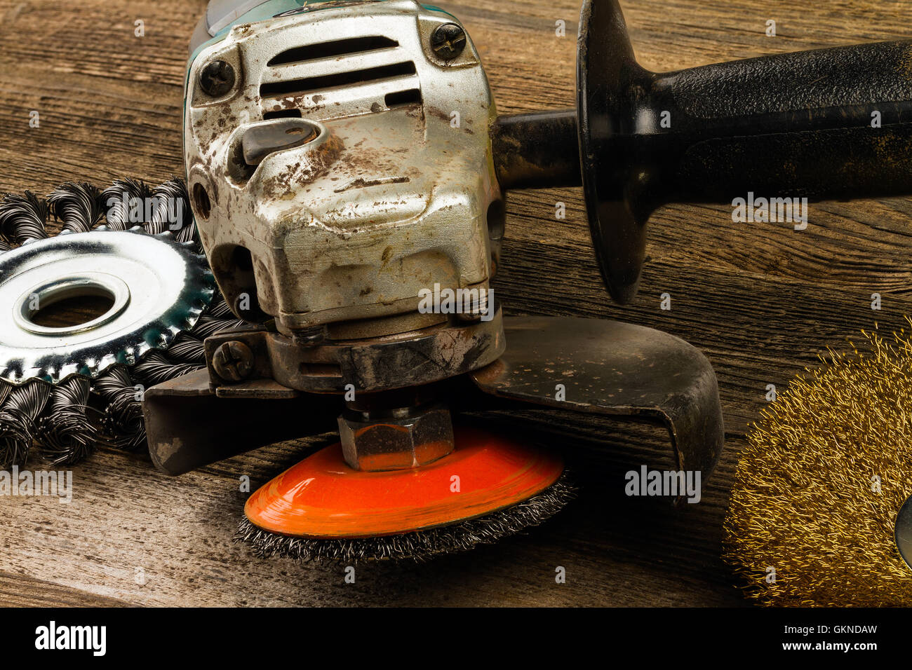 used grinding machine with worn and new metal brushes on wooden ...