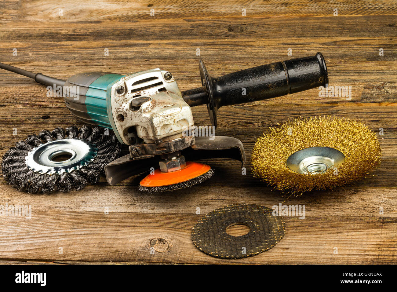 used grinding machine with worn and new metal brushes on wooden ...