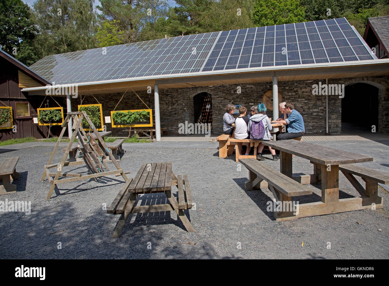 BIPV solar panels on roof of cafe building with people eating outside ...