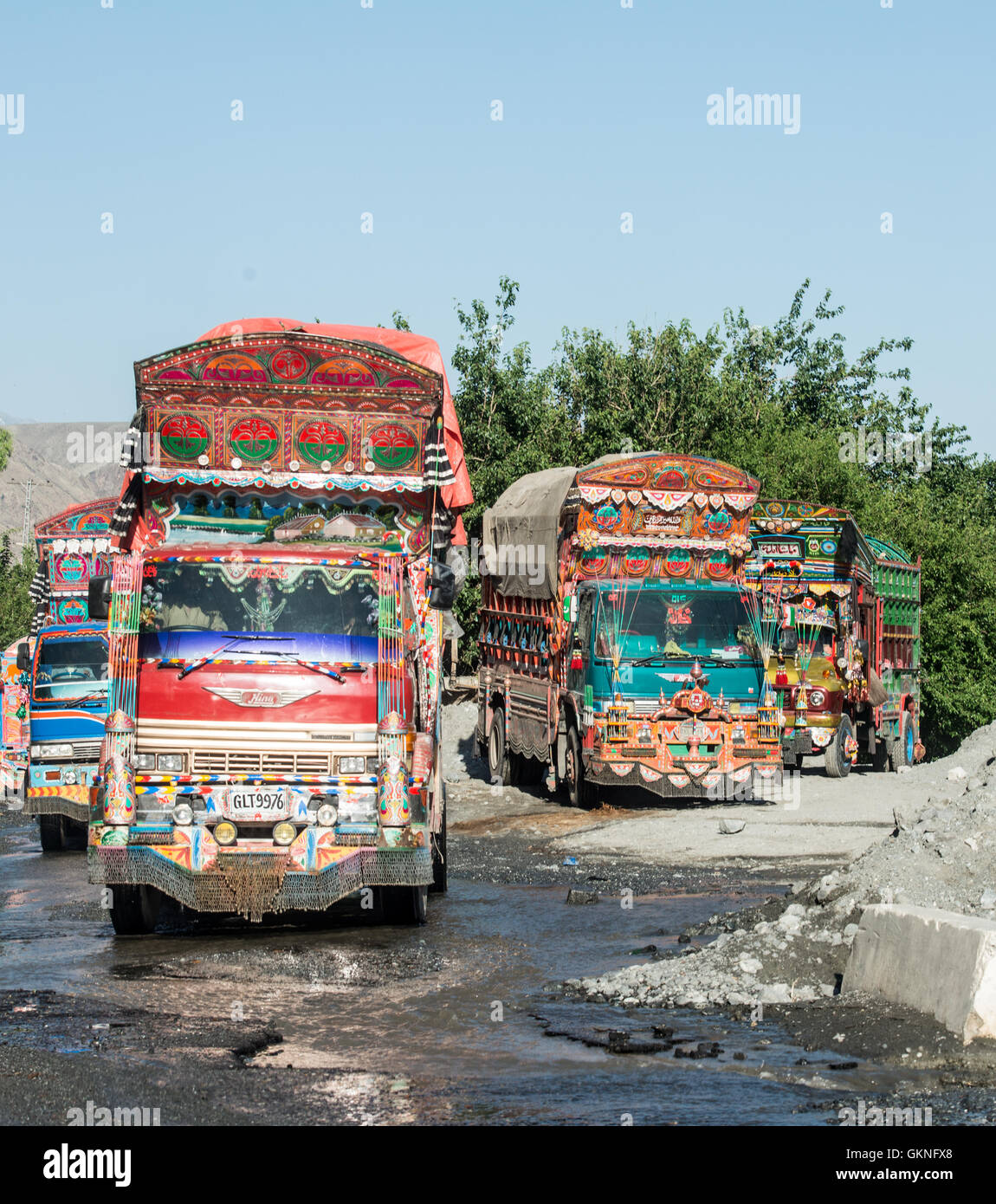 Jingly trucks crossing a ford in northern Pakistan on the Karakoram ...